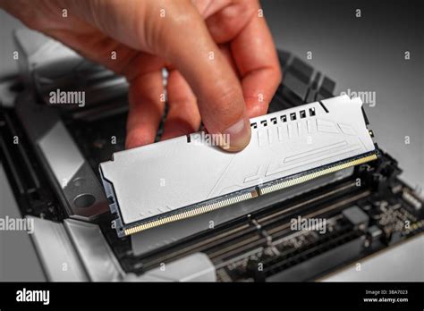 A Person Is Installing A White DDR Memory Module Into A Desktop Motherboard Stock Photo Alamy