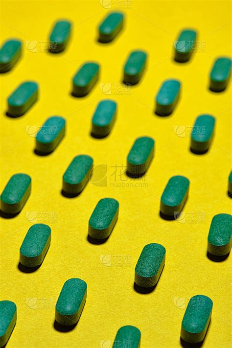 药用胶囊药丸和片剂在黄色的背景营养补充剂绿色维生素丸药丸图案在黄色的背景