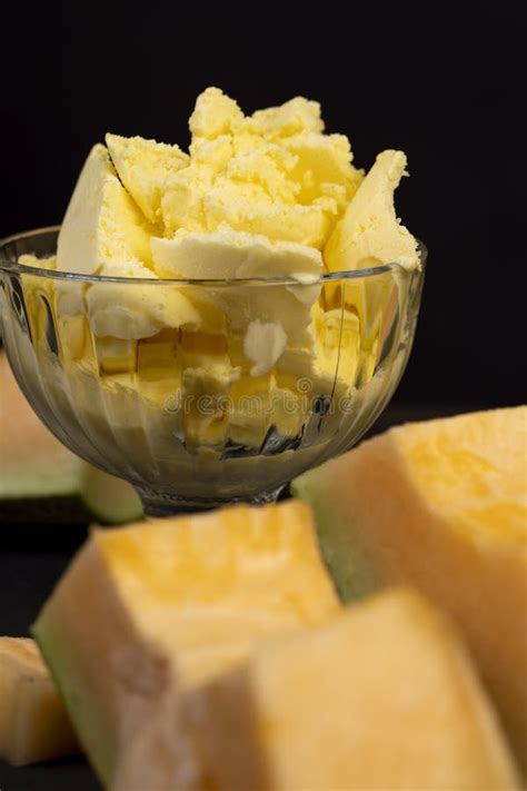 Sweet Creamy Ice Cream And Pieces Of Melon On The Table Stock Image