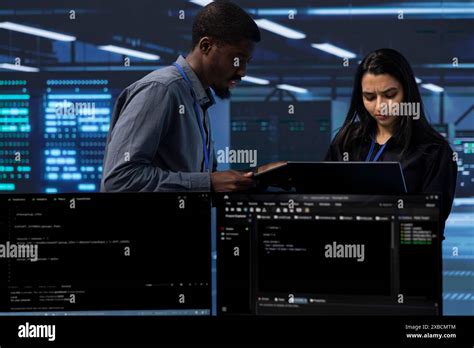 Engineers In Server Farm Checking Recovery Plan Monitoring Tech
