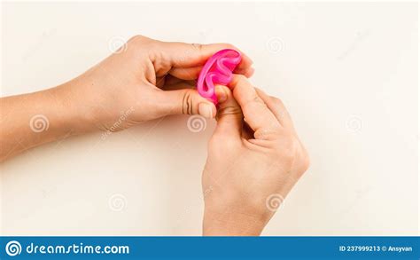 pink menstrual cup folded with a e fold method stock image image of