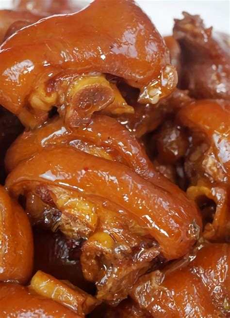 A White Bowl Filled With Meat Covered In Sauce