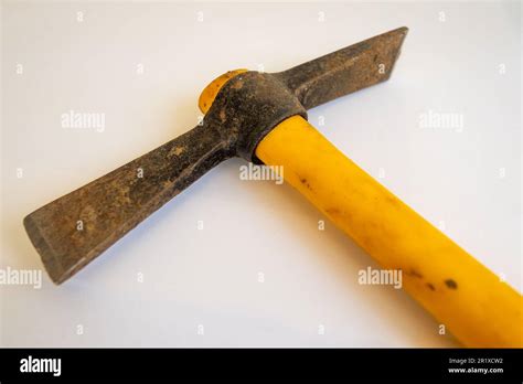 Old Used Iron Chisel Hand Tool Close Up With Yellow Handle Isolated