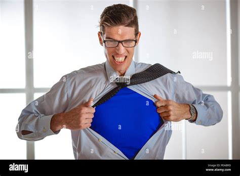 Angry Businessman Ripping Open His Shirt And Exposing A Superhero Blue
