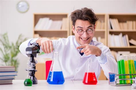 The Mad Crazy Scientist Doctor Doing Experiments In A Laboratory Stock