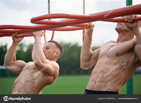 Two Shirtless Bodybuilders Doing Pull Ups Outdoors Stock Photo By Serhii Bobyk Gmail
