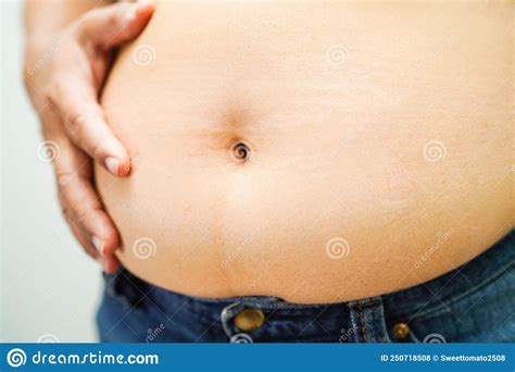 Asian Woman Show Fat Belly Big Size Overweight And Obesity At Office