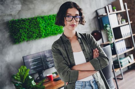 Confident Female Programmer Standing In A Modern Workspace Showcasing
