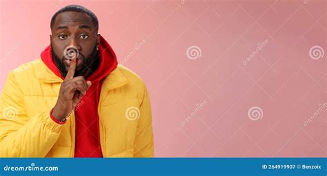 Waist Up Serious Looking African American Bearded Man In Yellow Jacket