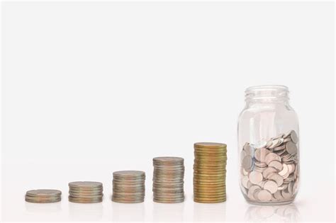 Premium Photo Growth Of Coin Stack And Money In Glass Bottle On White