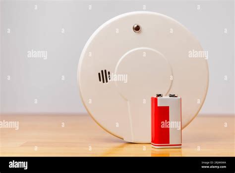 9v Alkaline Battery With Home Smoke Detector Background Nine Volt