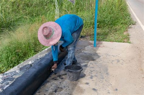 Premium Photo Workers Plastering The Edge Of The Footpath With Exposed Aggregate Finish