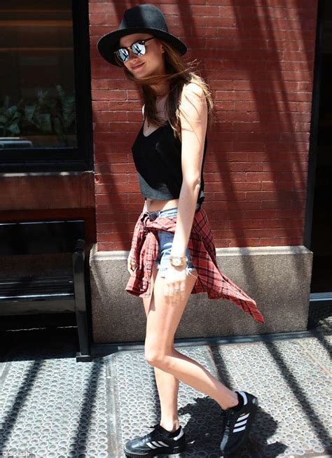 Behati Prinsloo Bares Her Midriff In Grunge Ensemble As Fiance Adam Levine Sports AC DC T Shirt