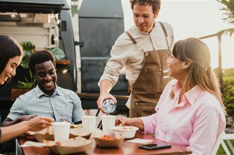 Premium Photo Happy Friends Toasting Drinks On Table