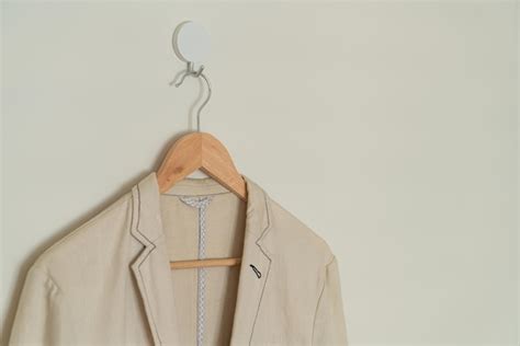 Premium Photo Beige Suit Hanging With Wood Hanger