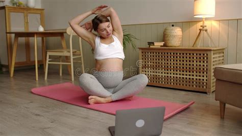 Pregnant Attractive Woman Do Yoga Exercises With Laptop Watch Online