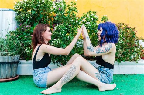Premium Photo Happy Young Women Playing Patty Cake In Backyard