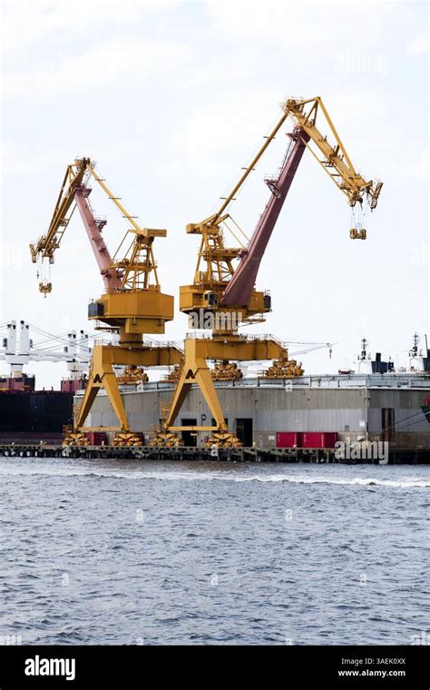 Heavy Duty Yellow Cranes On Rails For Loading Cargo Onto Ships At A