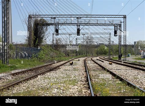 Three Rail Tracks Railway With Overhead Electrical Train Line Stock