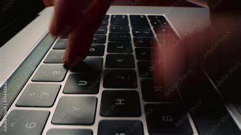 Low angle shot moving across laptop computer keyboard as woman types quickly K Stock 비디오