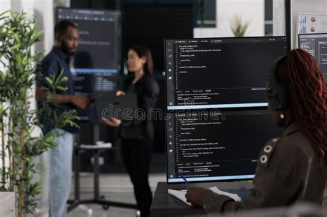 Multi Ethnic Team Of Software Developers Analyzing Code Stock Image