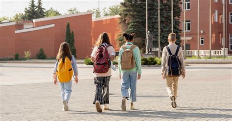 아침에 학교에 가는 배낭을 메고 있는 현대 학생들의 그룹 사진 Unsplash의 후면보기 이미지