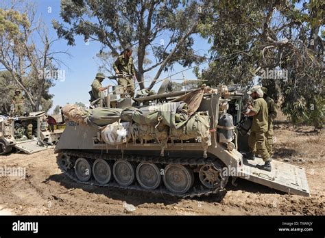 Israeli Soldiers Work On An Armored Personnel Carrier At A Staging Area