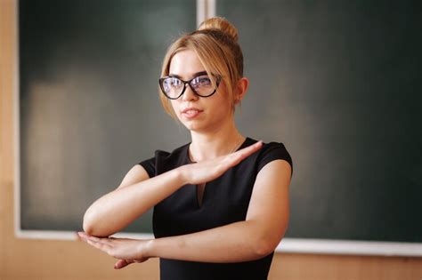 Premium Photo Young Female Teacher In Glasses Stand In Front Of