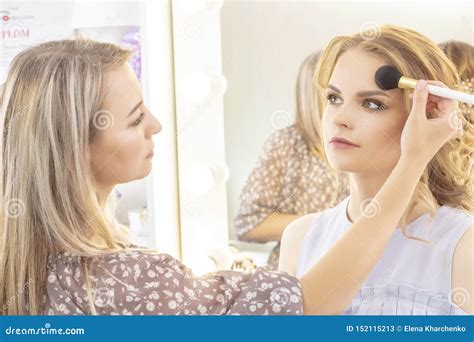 Makeup Artist Applies Model Makeup On Face Bridal Makeup Light Evening Make Up In Nude Tones