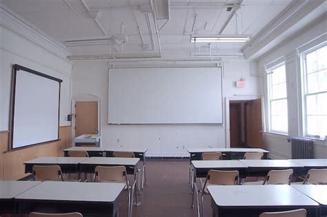 Modern Empty Classroom With Neatly Arranged Desks And Dual Whiteboards