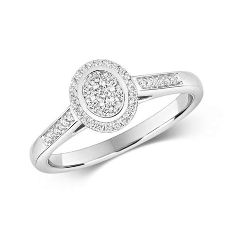 Oval Shaped Diamond Cluster Ring With Diamond Shoulders In 9ct White