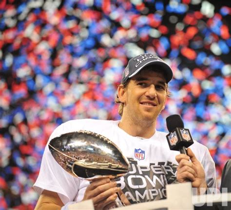 Photo Super Bowl Mvp Eli Manning Celebrates On Podium Super Bowl Xlvi