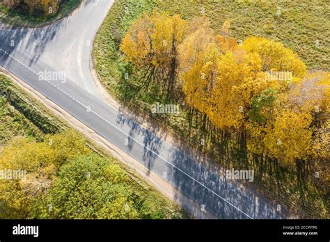 Aerial Top View Of A Rural Asphalt Road Through Farmland In Sunny