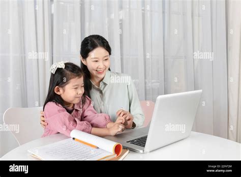 Asian Korean Mother And Daughter Taking Online Classes On Tablet Stock