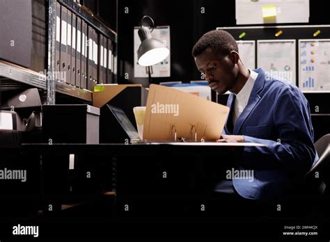Police Officer Holding Document With Confidential Case Reading Victim Information In Federal Police Officer Holding Document With Confidential Case Reading Victim Information In Federal