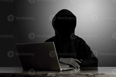 Mysterious Man Wearing Black Hoodie Using Laptop In The Dark Room
