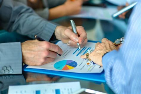 Business People Working On Charts And Graphs Premium Ai Generated Image