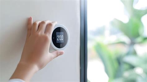 Premium Ai Image A Hand Adjusting The Heating Thermostat