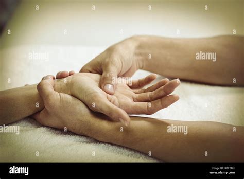 Female Physiotherapist Giving Patient Hand Massage Hi Res Stock
