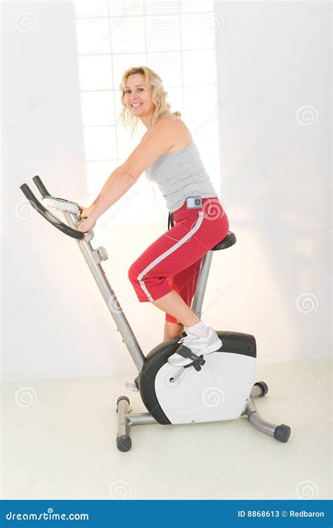 Woman On Exercise Bike Stock Image Image Of Bicycle Healthclub 8868613