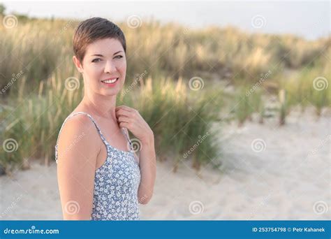 Attractive Short Haired Woman In Her Thirties Dressed In Light Summer
