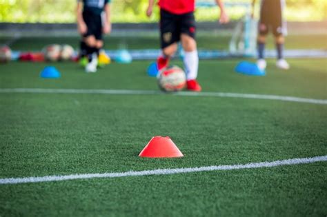 Premium Photo Low Section Of Woman Playing Soccer On Field