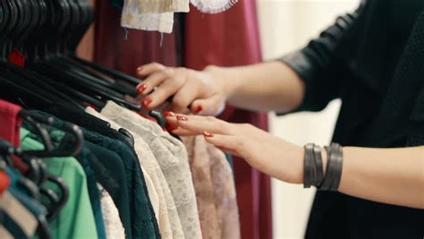 Young Woman Fingering Clothes In Stock Footage Video 100 Royalty Free