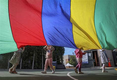 Elementary School Students Play A Parachute Game During Recess