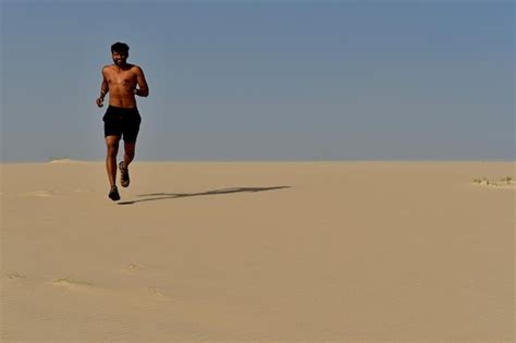 Premium Photo Full Length Of Shirtless Young Man Running On Sand At