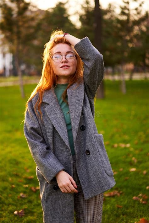 Redhead Smiling Pretty Woman Walking In Park On Sunny Autumn Day