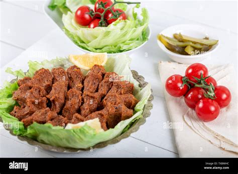 Turkish Food Cig Kofte With Lemon Lettuce And Parsley On Silver Plate