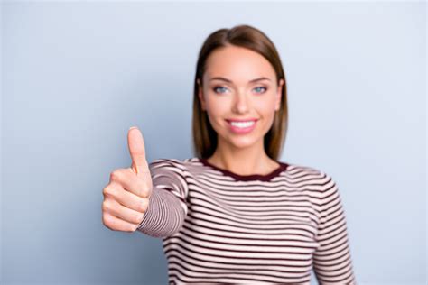 Portrait Of Nice Brunette Girl In Sweater On Blurred Grey Background