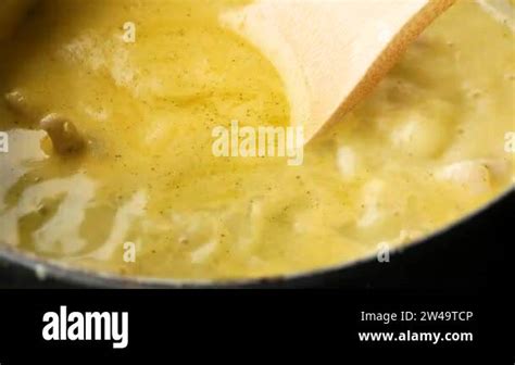 Close Up Cooking Of Chicken Green Curry Adding Fresh Green Thai Eggplant Chili And Basil Into