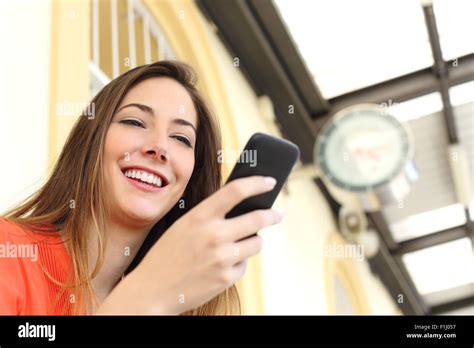 Woman Buying Ticket With A Mobile Phone In A Train Or Bus Station With